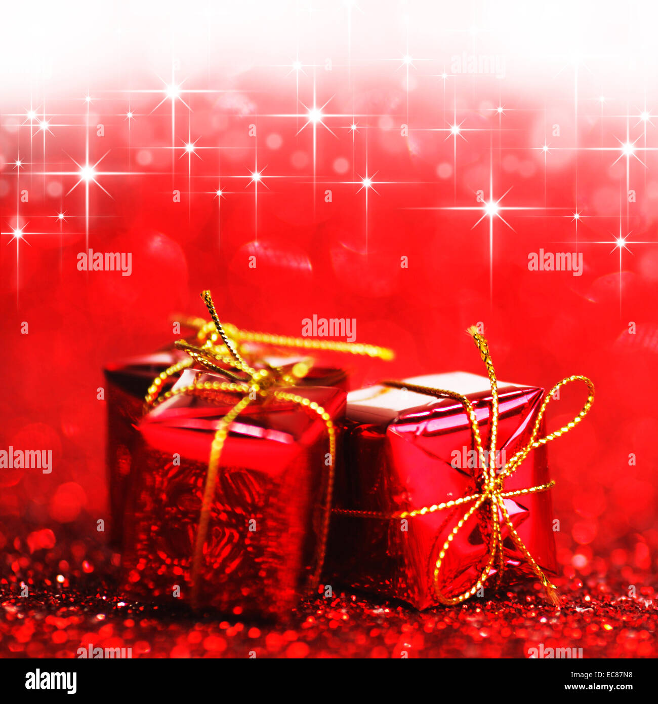 Holiday gifts over shiny glitter background with stars Stock Photo - Alamy