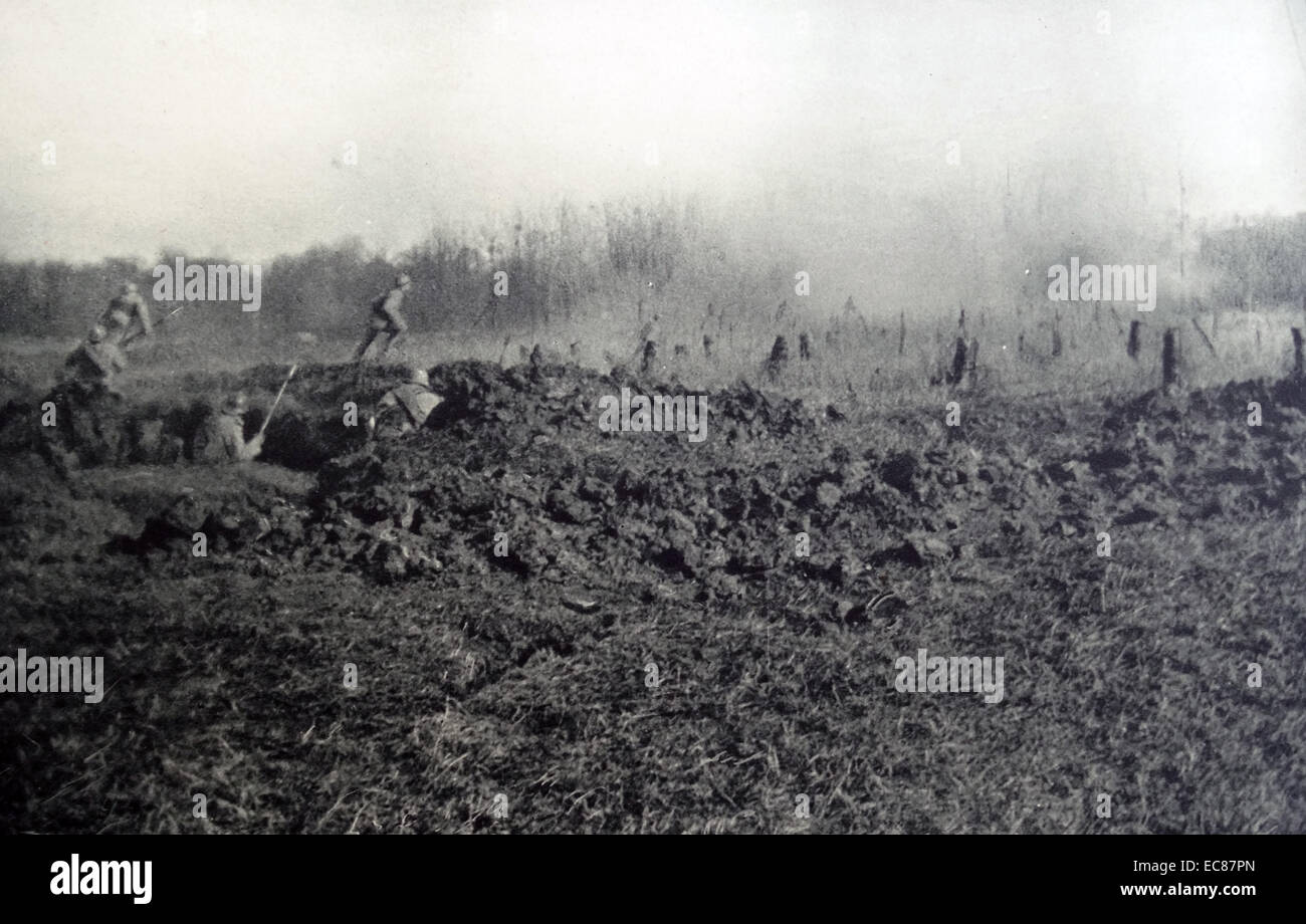 Photograph of French Soldiers advancing out of the trenches under fire ...