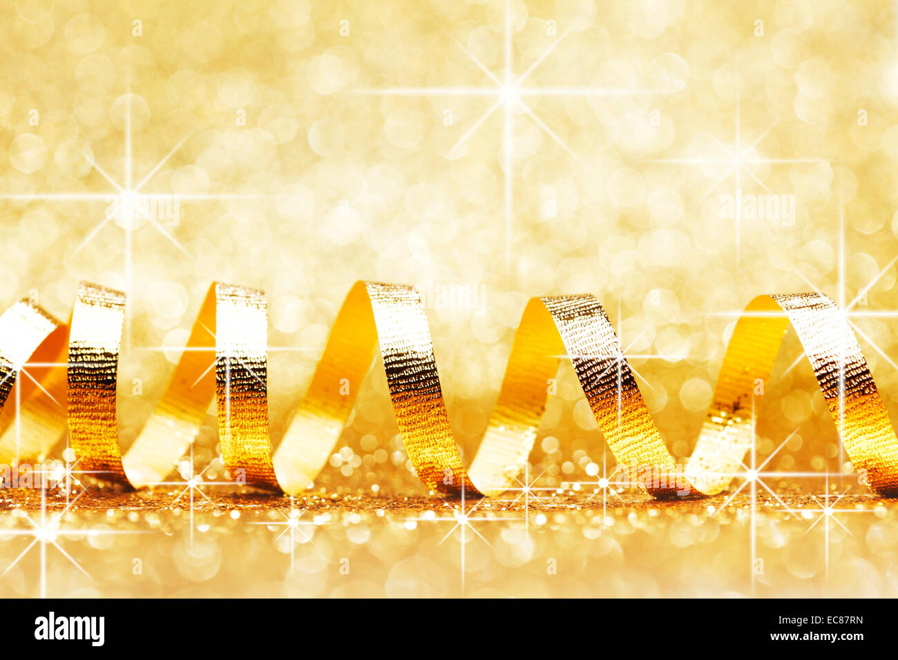 Holiday ribbon on shiny glowing stars gold background Stock Photo - Alamy
