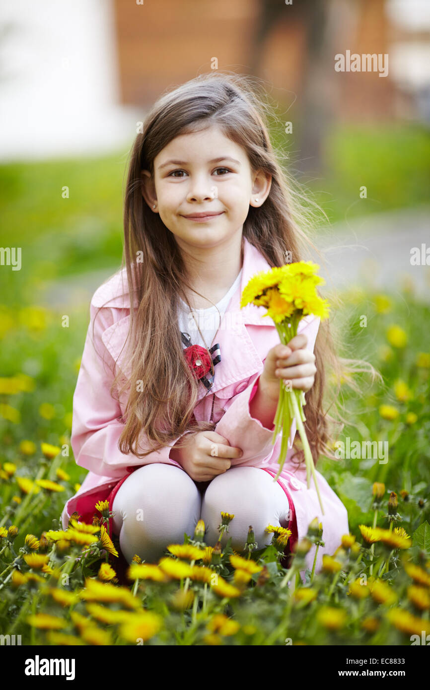 girl sitting in field of flowers Stock Photo - Alamy