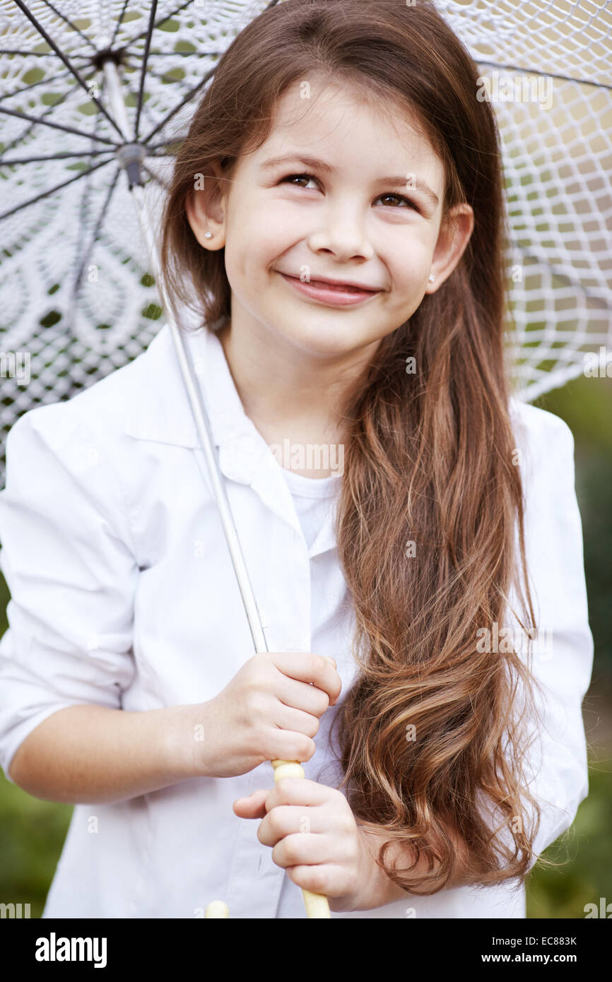 pretty girl with lace umbrella in white suit Stock Photo - Alamy