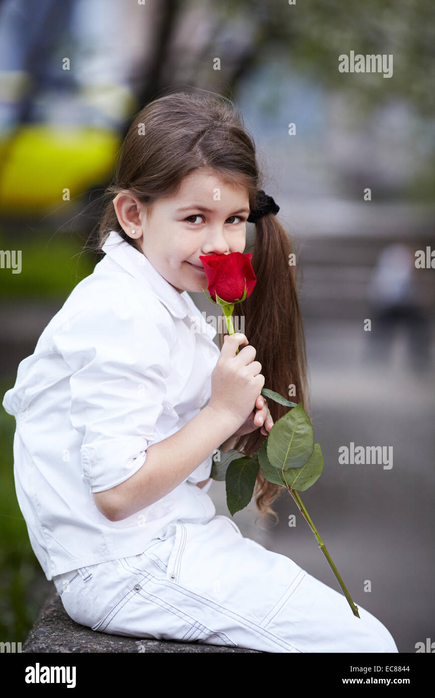 Child smelling rose hi-res stock photography and images - Alamy