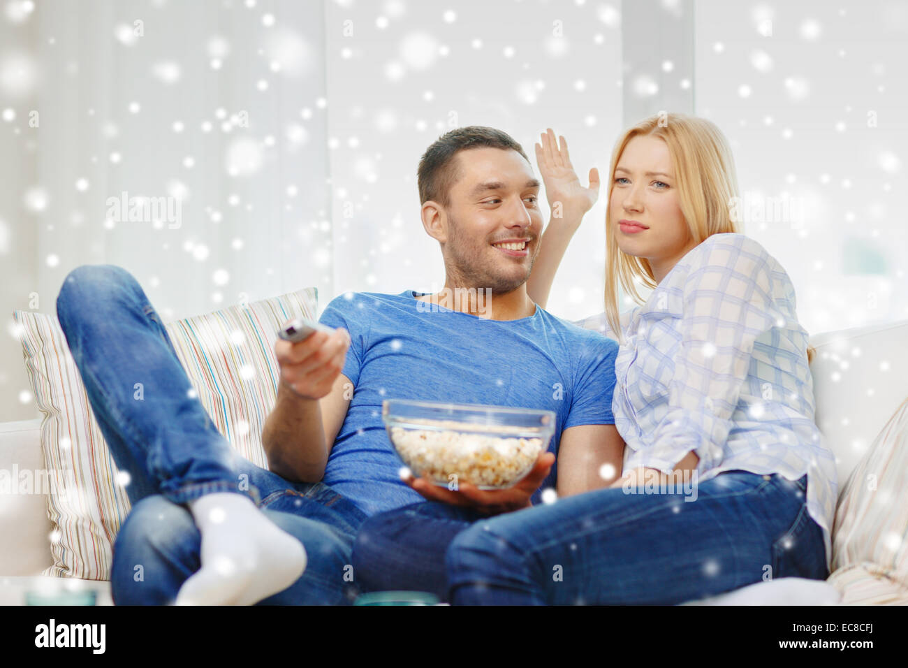 Smiling lovers watching television hi-res stock photography and images ...
