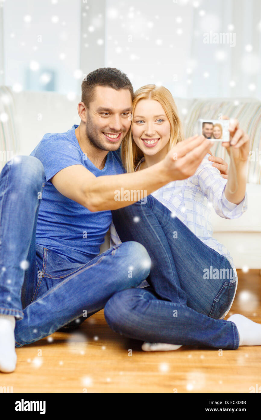 smiling couple taking picture with digital camera Stock Photo - Alamy