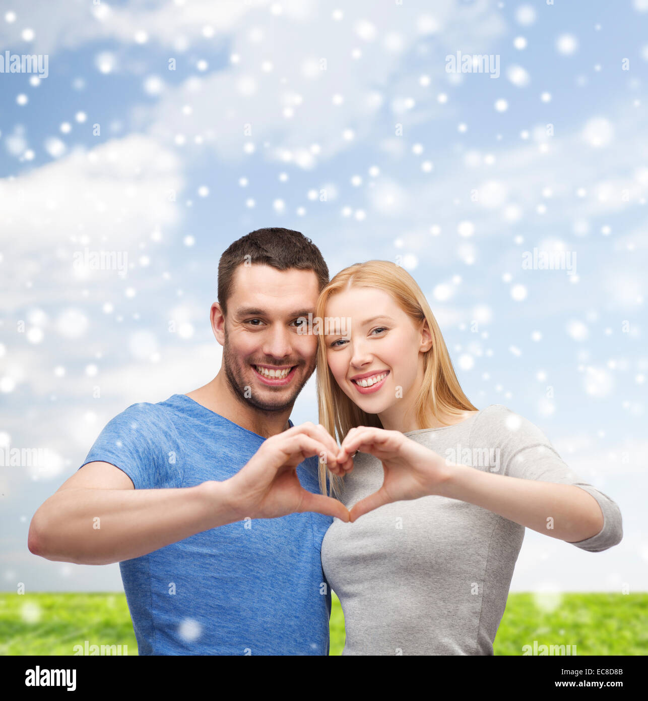 happy couple making heart gesture and hugging Stock Photo - Alamy