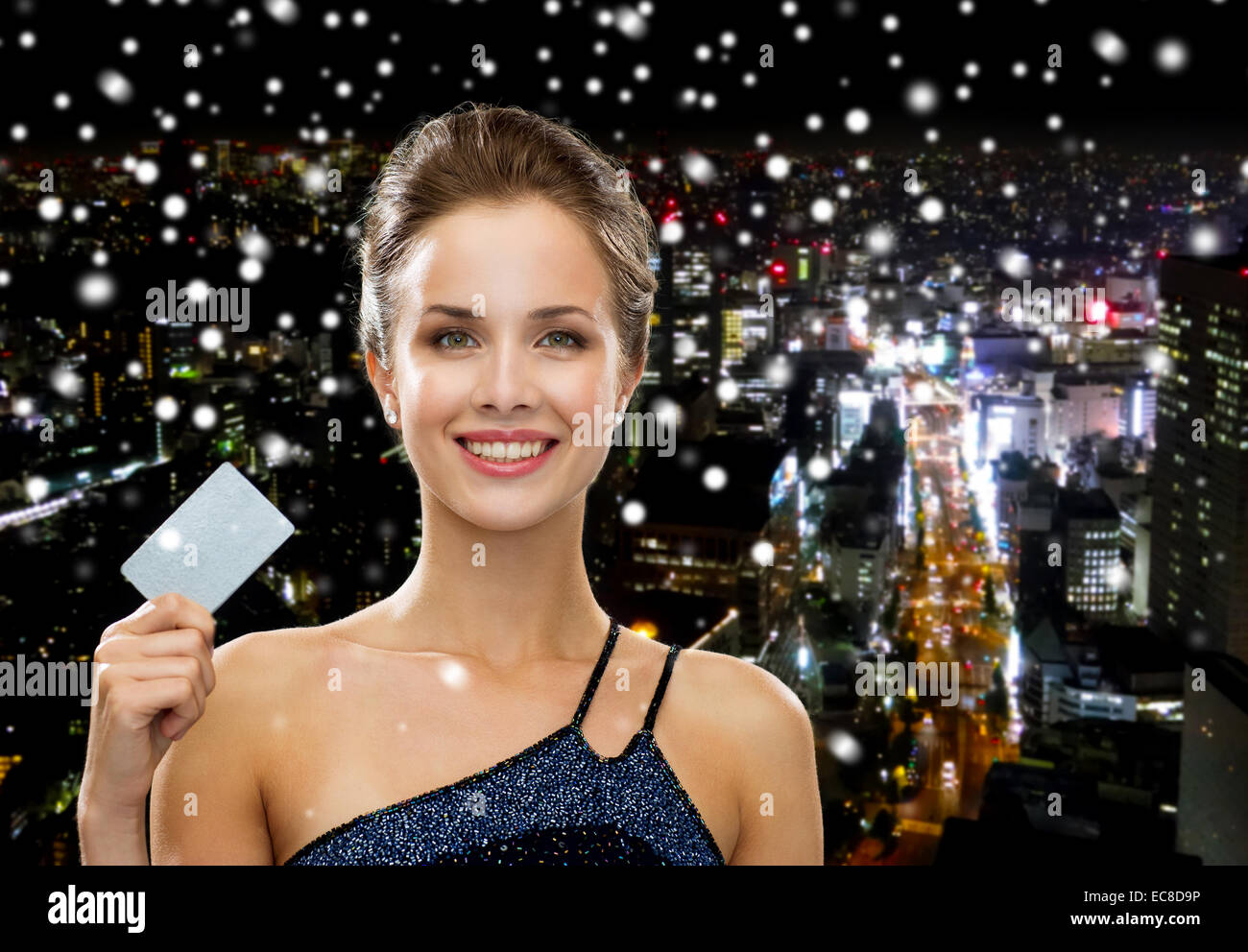 smiling woman in evening dress holding credit card Stock Photo - Alamy