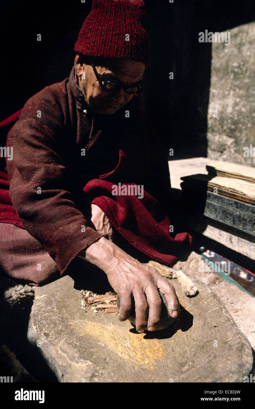 Ladakh Tibet Traditional elder old man healer pounding medicines shaped ...