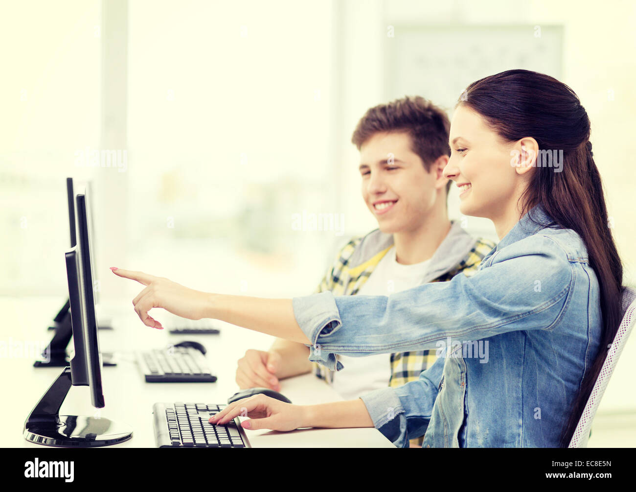 two smiling students in computer class Stock Photo - Alamy