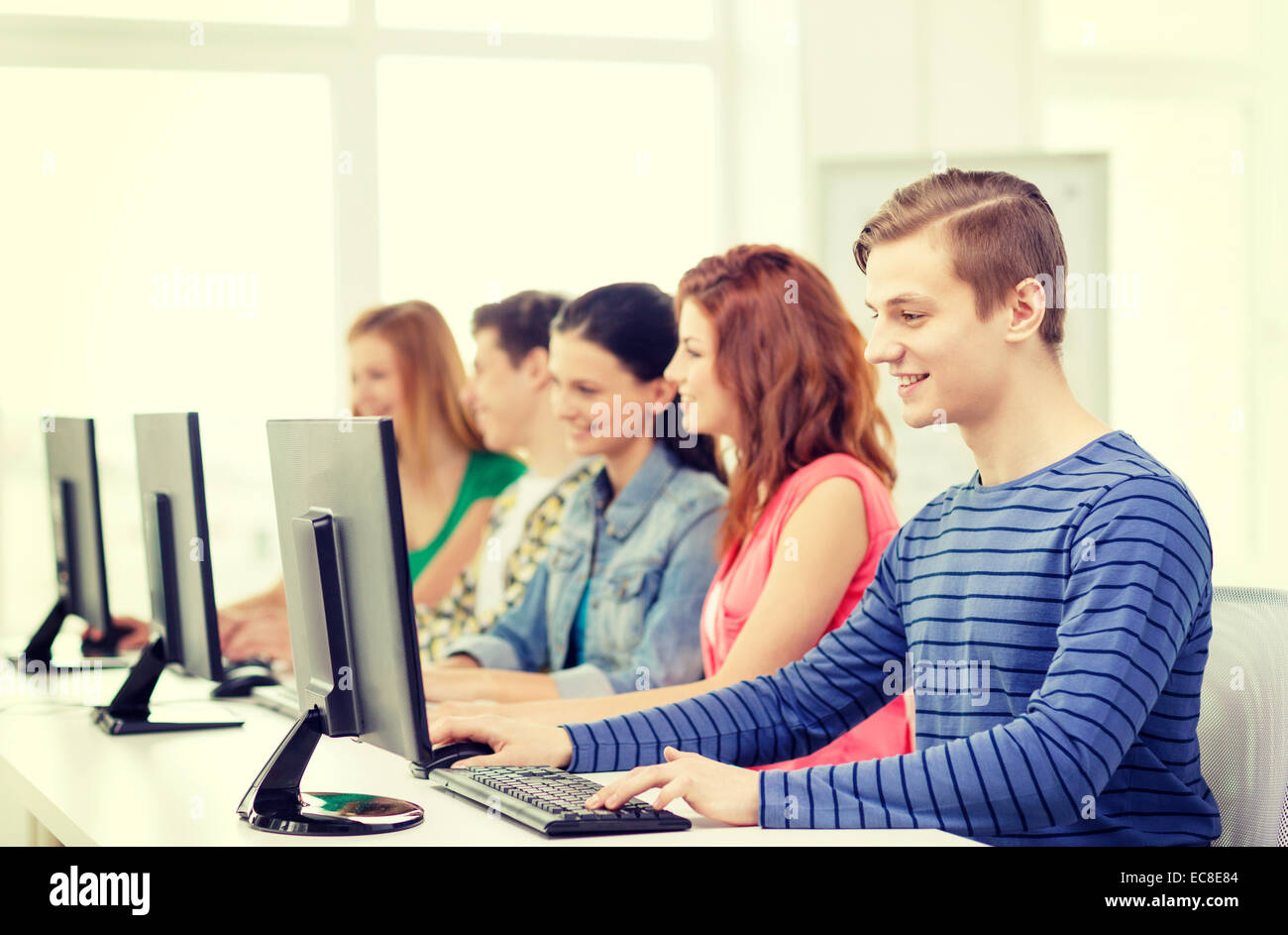 male student with classmates in computer class Stock Photo - Alamy