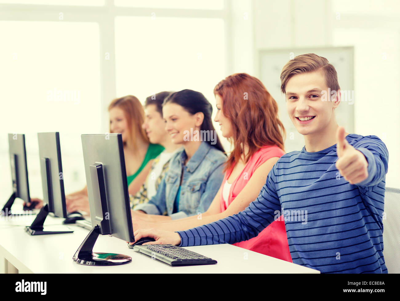 male student with classmates in computer class Stock Photo - Alamy