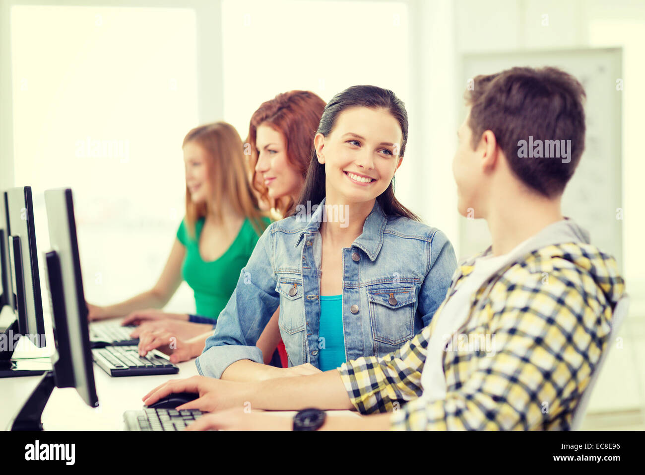 smiling students in computer class at school Stock Photo - Alamy