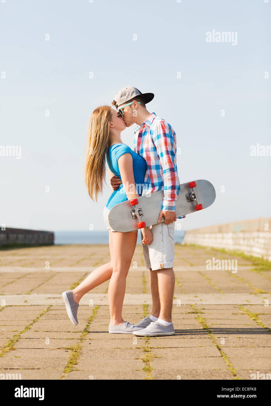 couple with skateboard kissing outdoors Stock Photo - Alamy