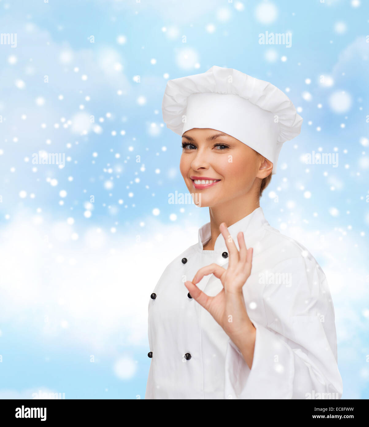 smiling female chef showing ok hand sign Stock Photo - Alamy