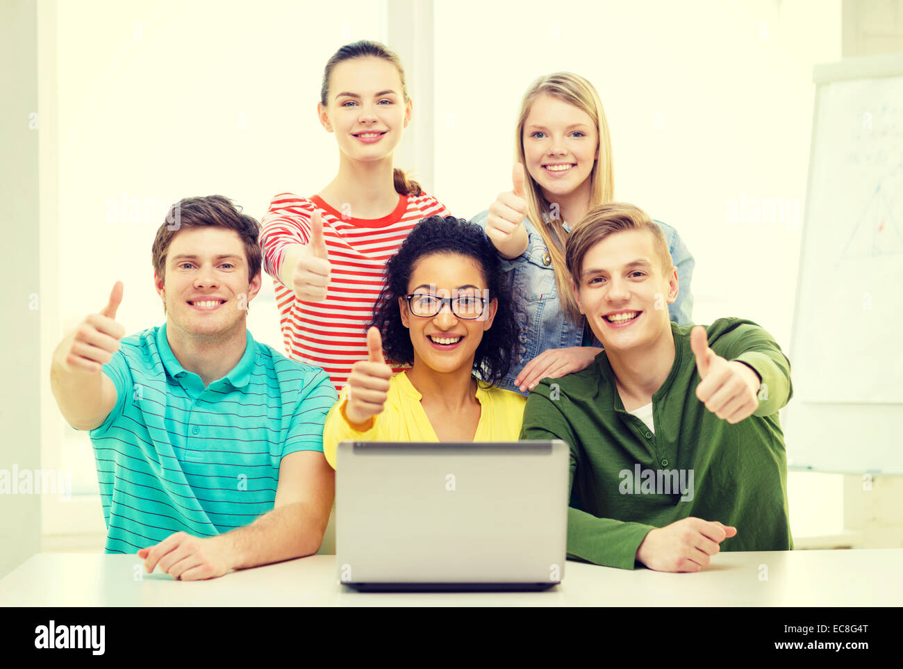 smiling students with laptop at school Stock Photo - Alamy