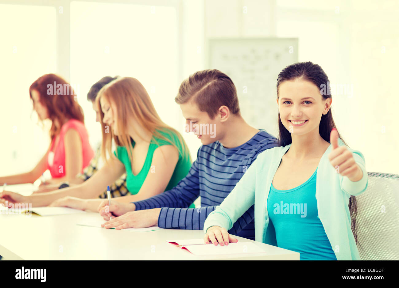 smiling students with textbooks at school Stock Photo - Alamy