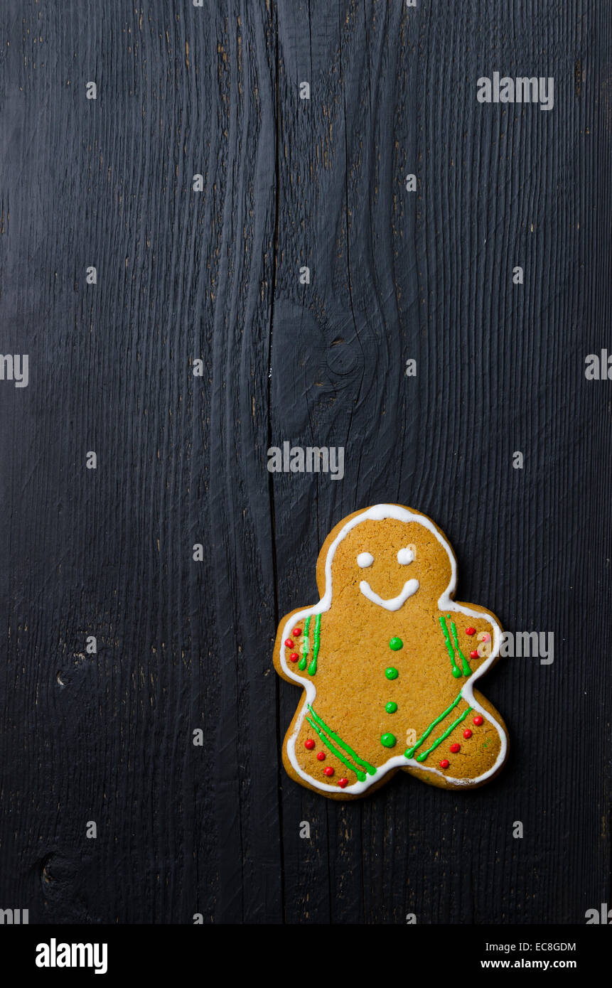 Homemade gingerbread man over black wooden table, above view Stock ...