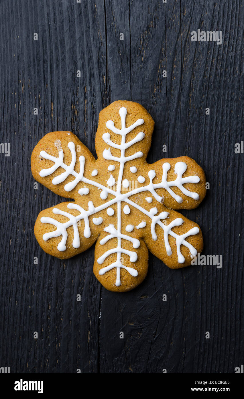 Homemade gingerbread star shape cookie over black wooden table, above ...