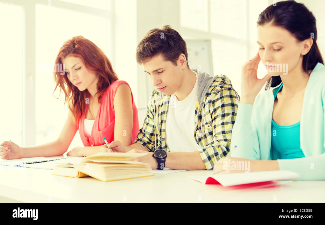 tired students with textbooks and books at school Stock Photo - Alamy