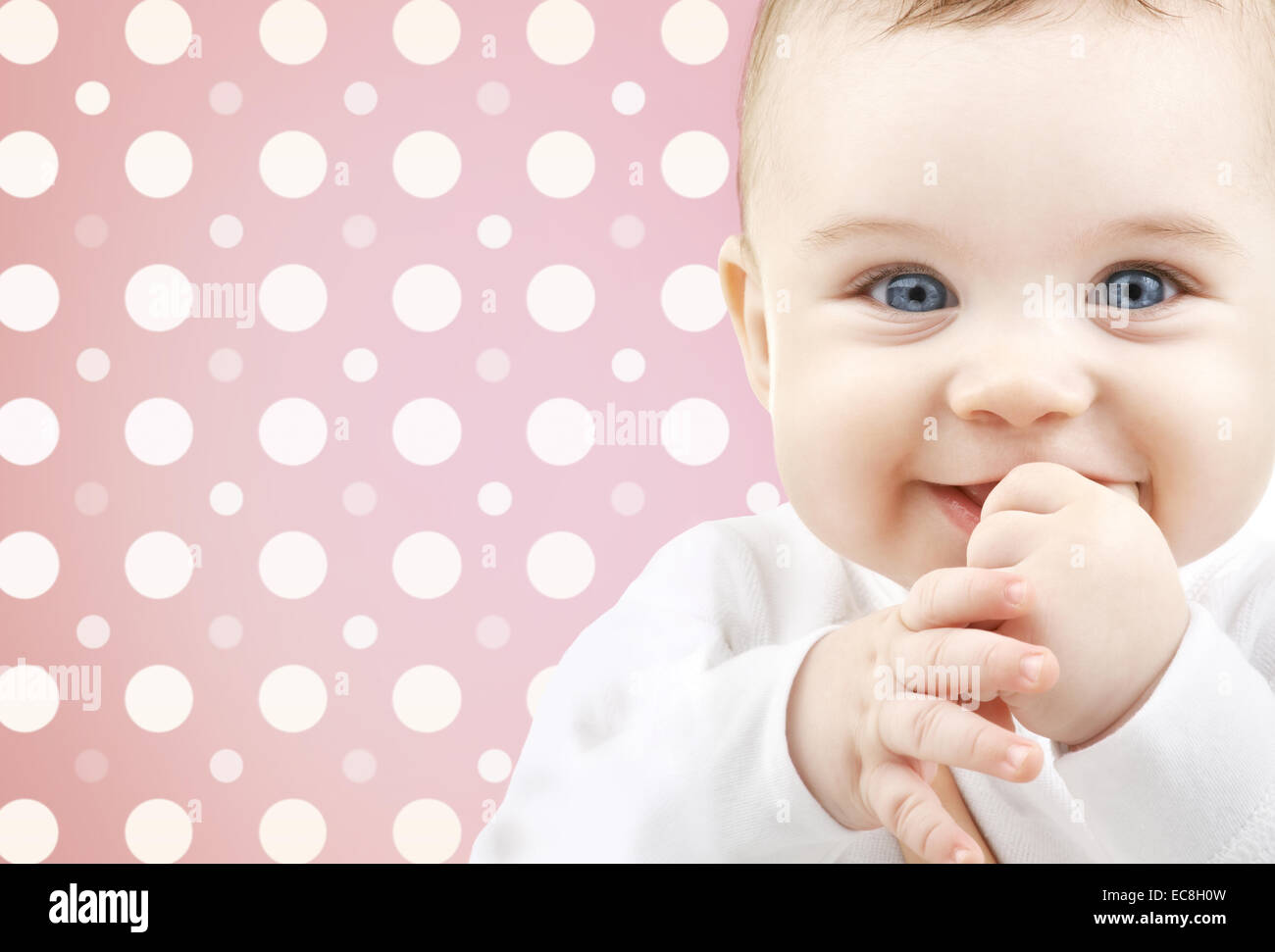 smiling baby girl face over pink polka dots Stock Photo - Alamy