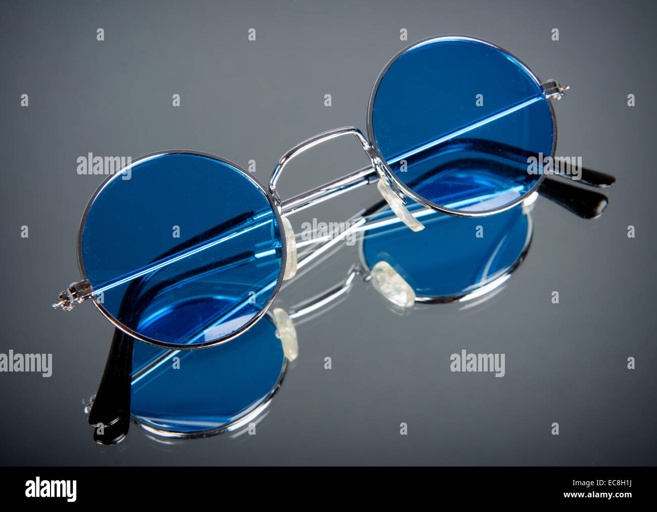 vintage blue glasses on the grey background Stock Photo - Alamy
