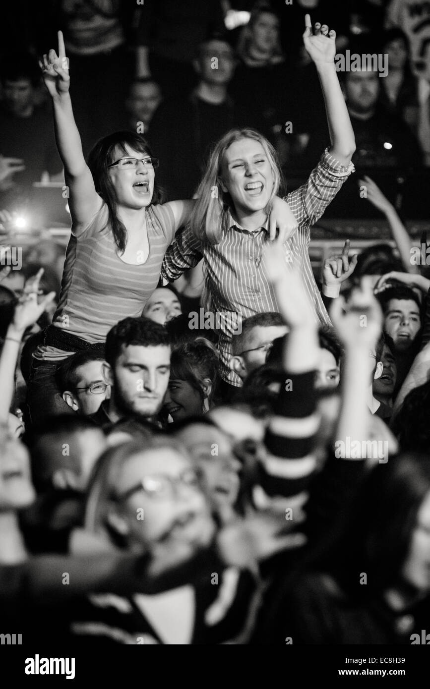 Music fans sitting on shoulders enjoying live concert / festival with ...