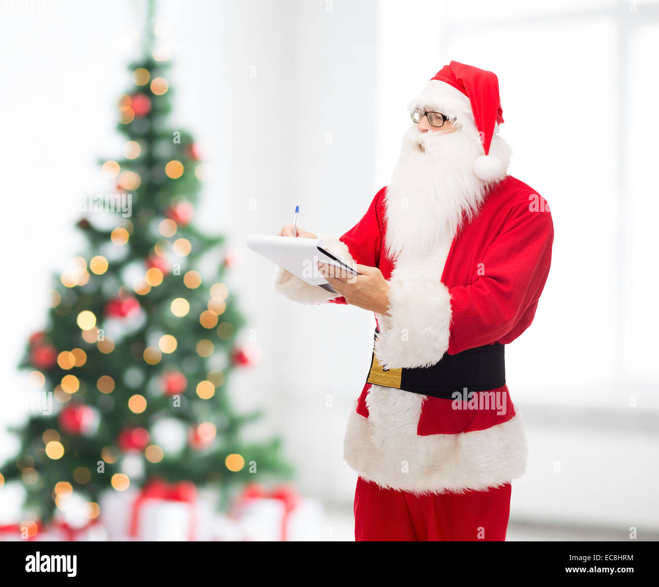 man in costume of santa claus with notepad Stock Photo - Alamy