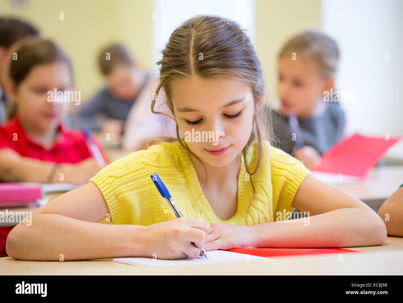group of school kids writing test in classroom Stock Photo - Alamy
