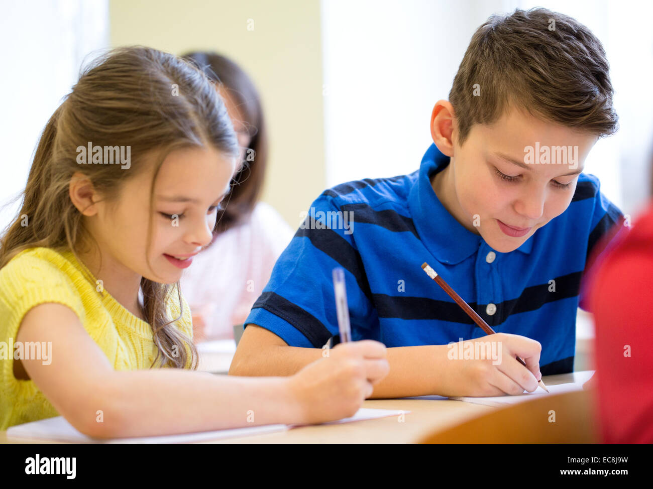 group of school kids writing test in classroom Stock Photo - Alamy
