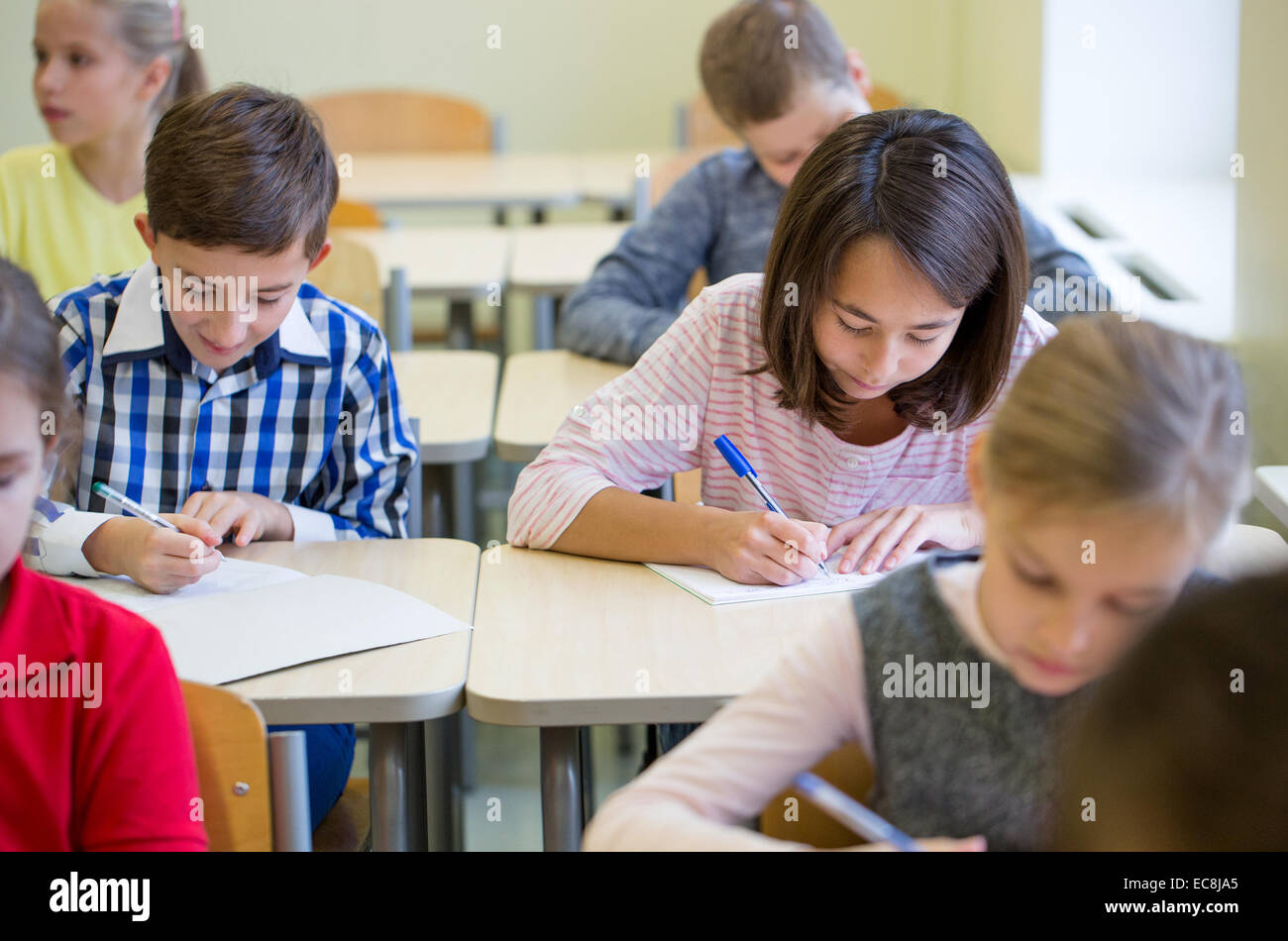 group of school kids writing test in classroom Stock Photo - Alamy
