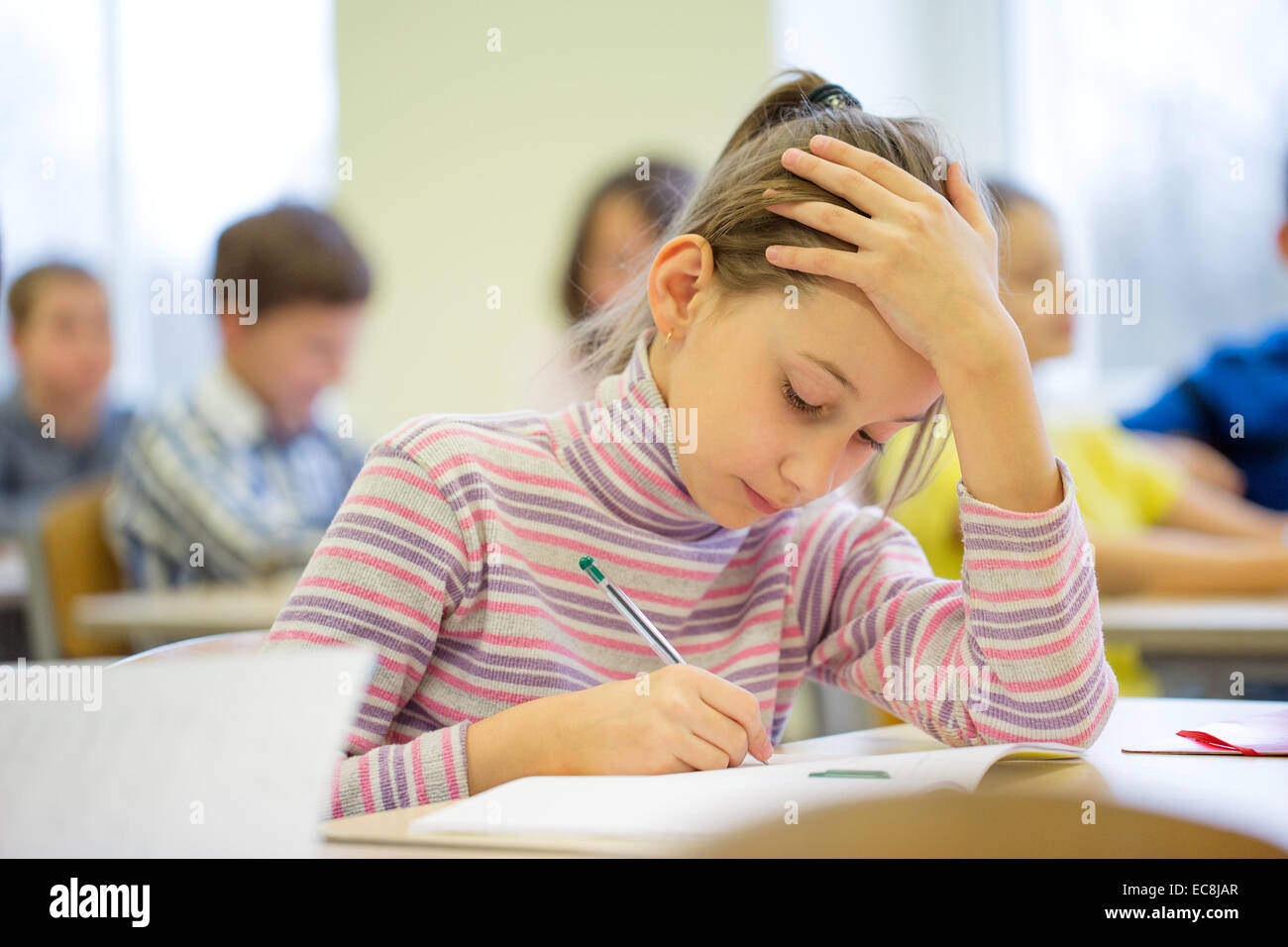 group of school kids writing test in classroom Stock Photo - Alamy
