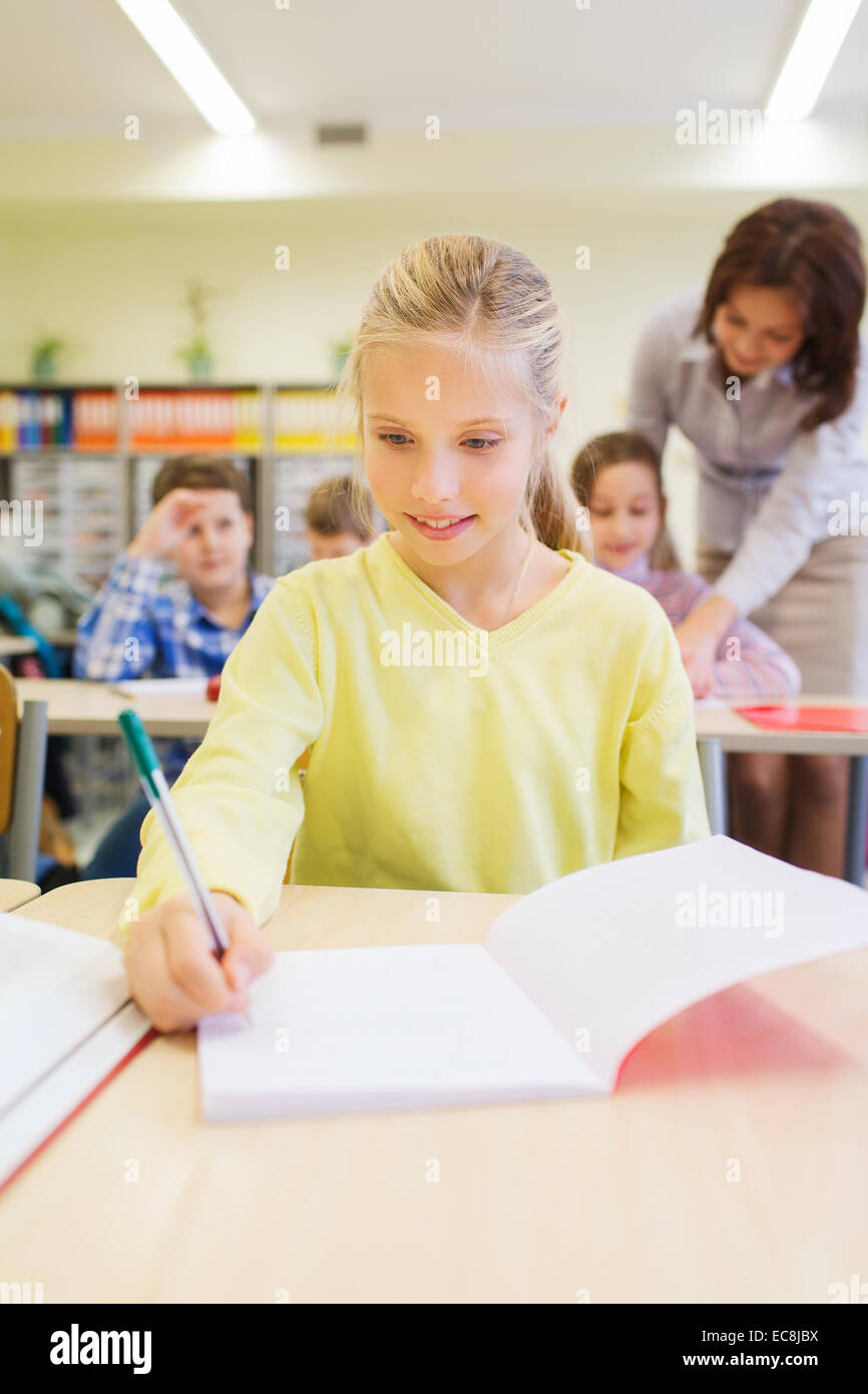 group of school kids writing test in classroom Stock Photo - Alamy
