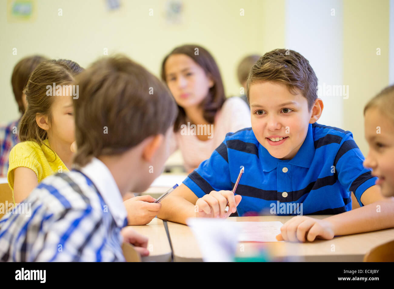 group of school kids writing test in classroom Stock Photo - Alamy