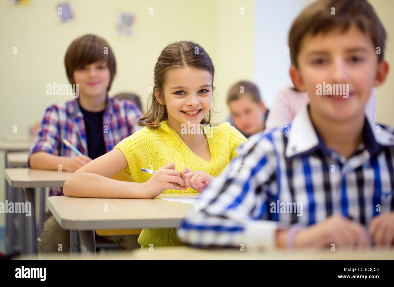 group of school kids with notebooks in classroom Stock Photo - Alamy
