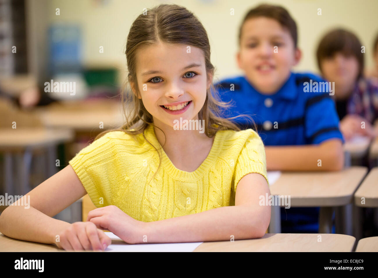group of school kids with notebooks in classroom Stock Photo - Alamy