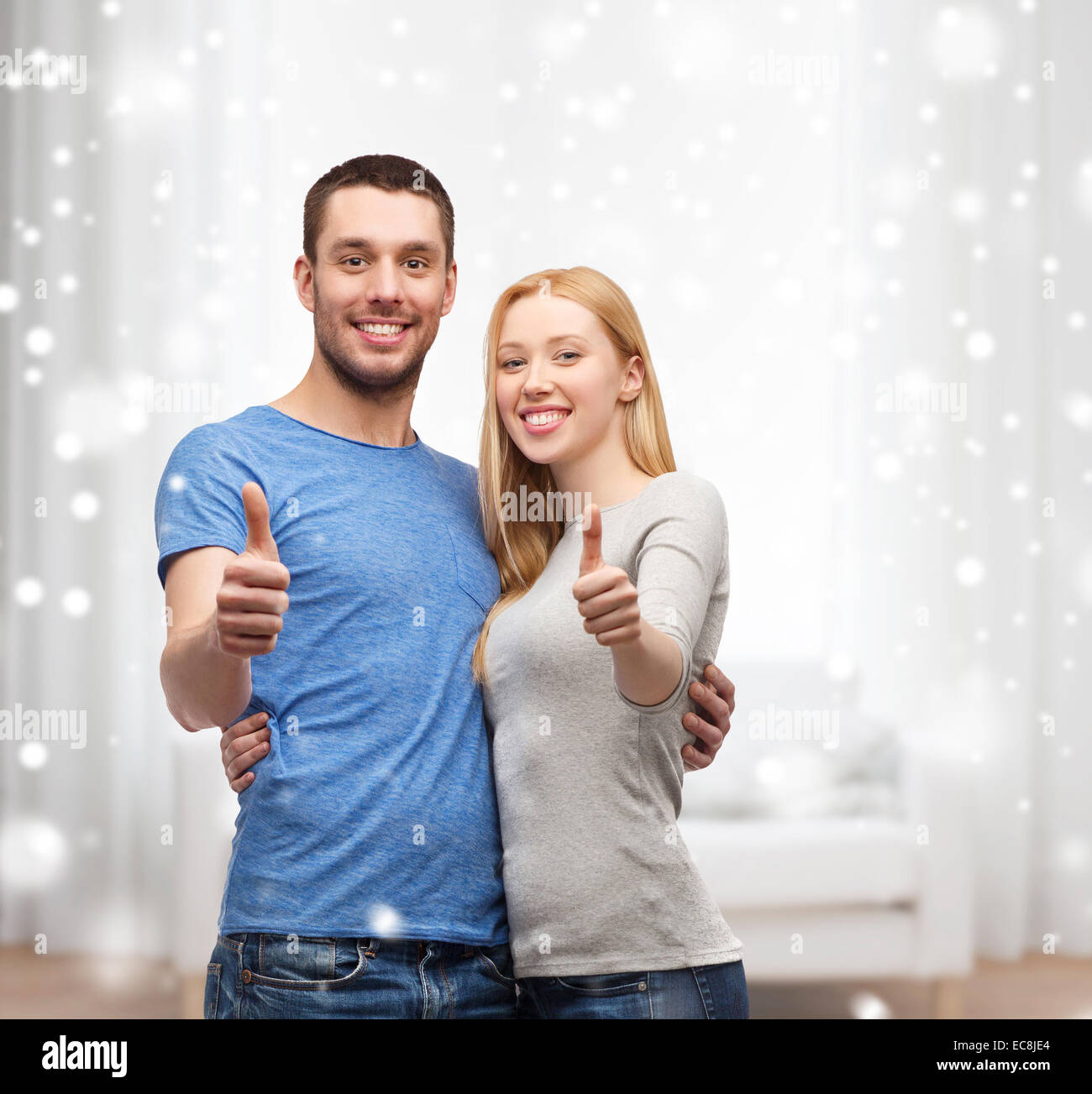 happy couple showing thumbs up and hugging Stock Photo - Alamy