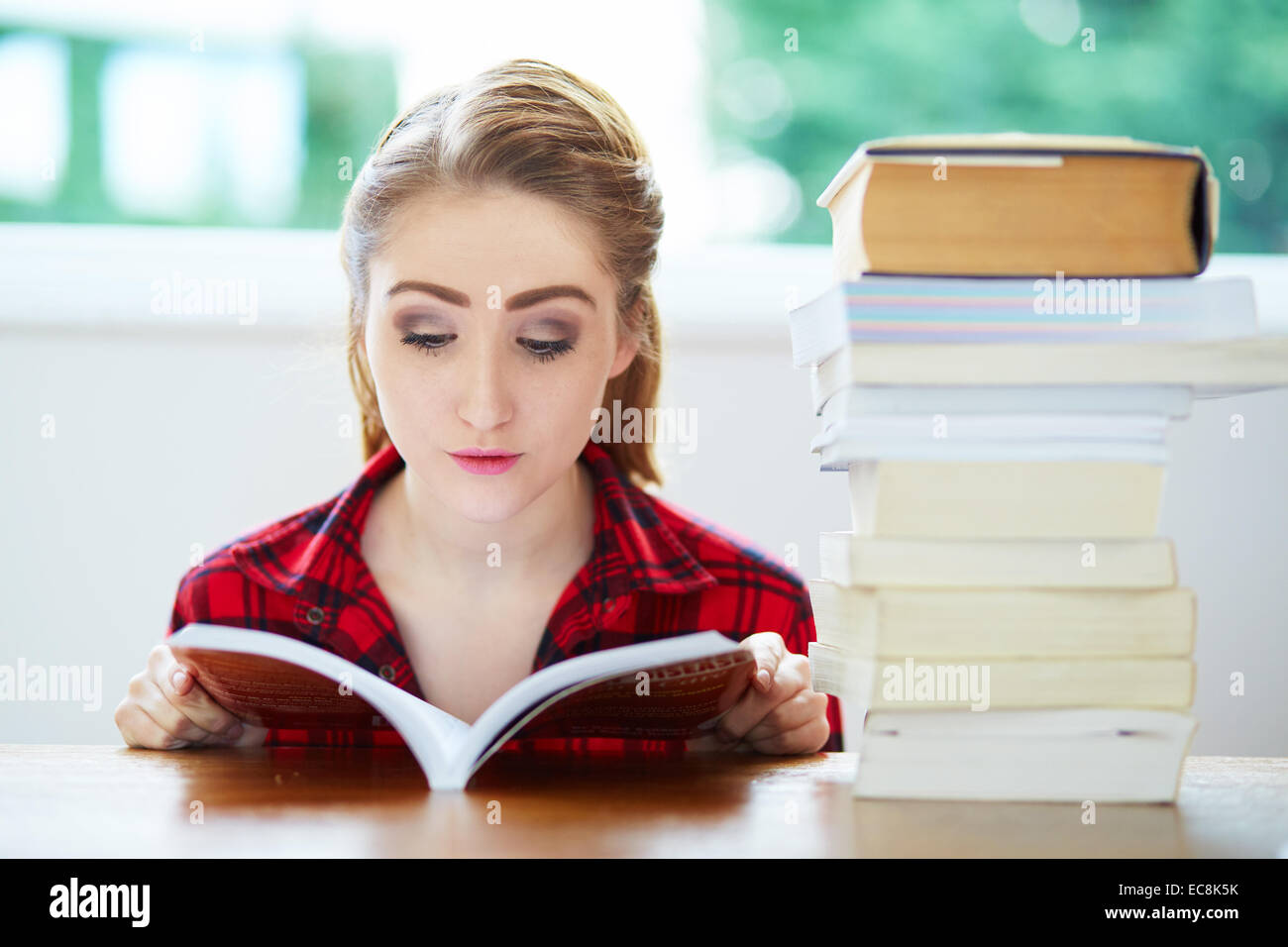 Girl reading books Stock Photo - Alamy