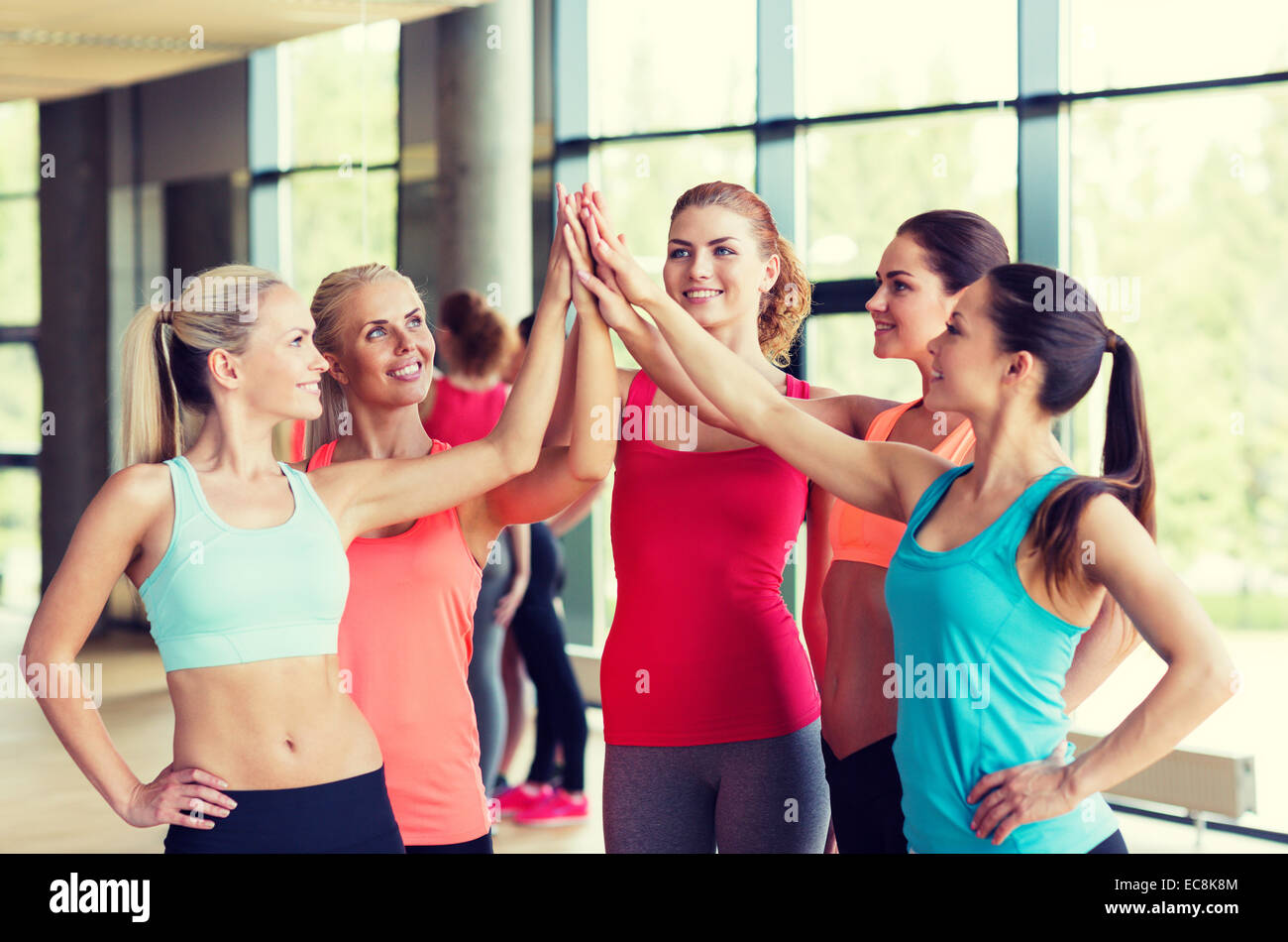 group of women making high five gesture in gym Stock Photo - Alamy
