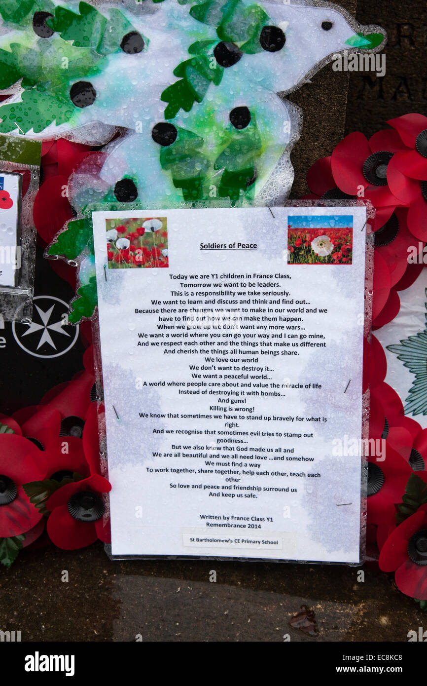 Close-up of a poppy wreath and poem written by local school children ...