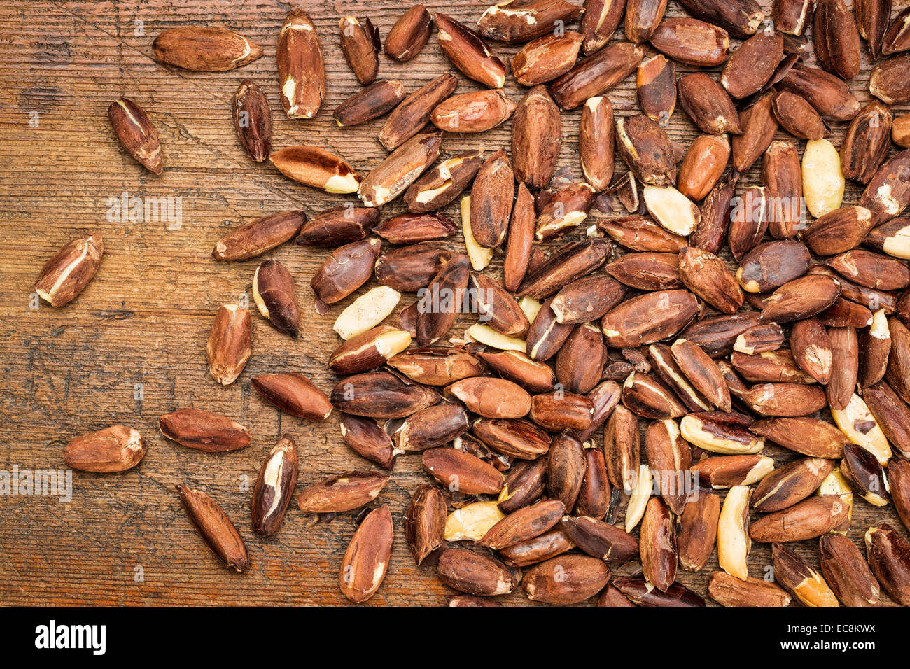 roasted pili nuts, grown in Philippines, against a grunge wood ...