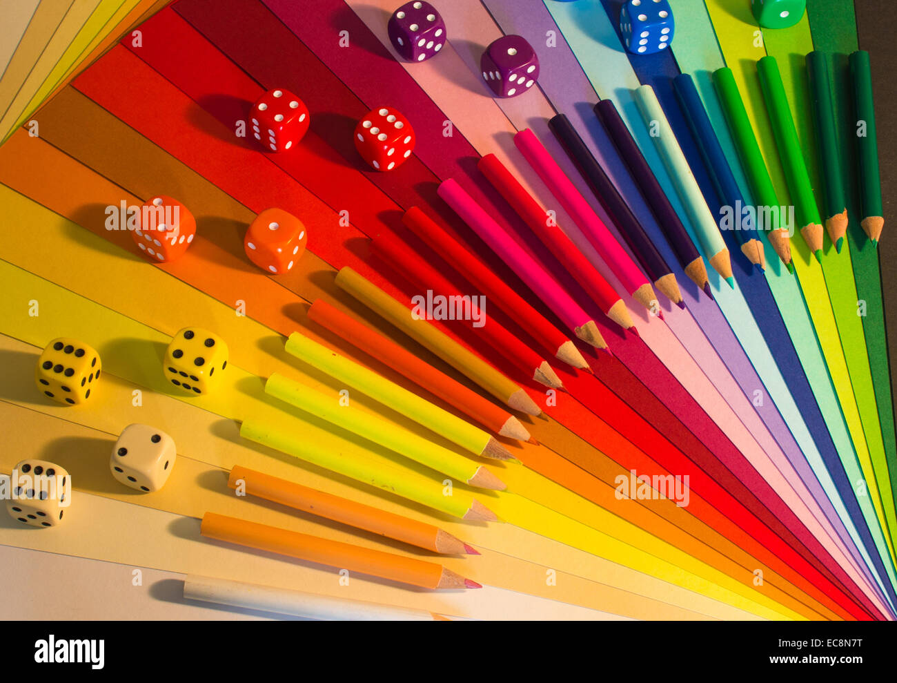 A creative sequence of small pencils and dice, placed on matching ...