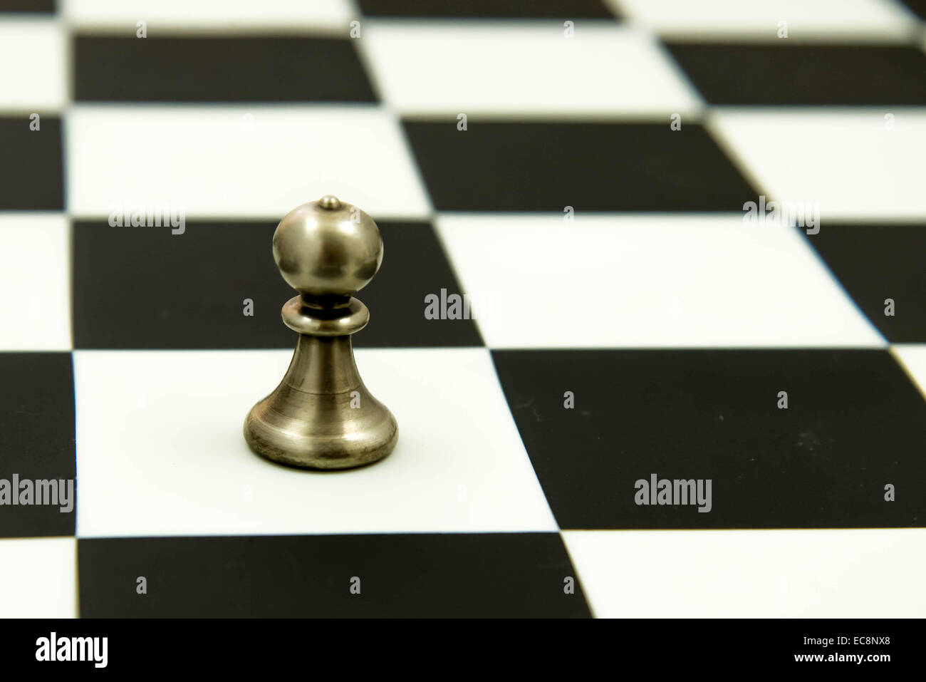 Classic chess game - pawn alone in front on chessboard Stock Photo - Alamy