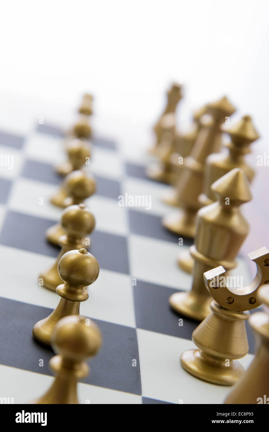 Classic chess game - gold playing pieces lined up on chessboard Stock ...