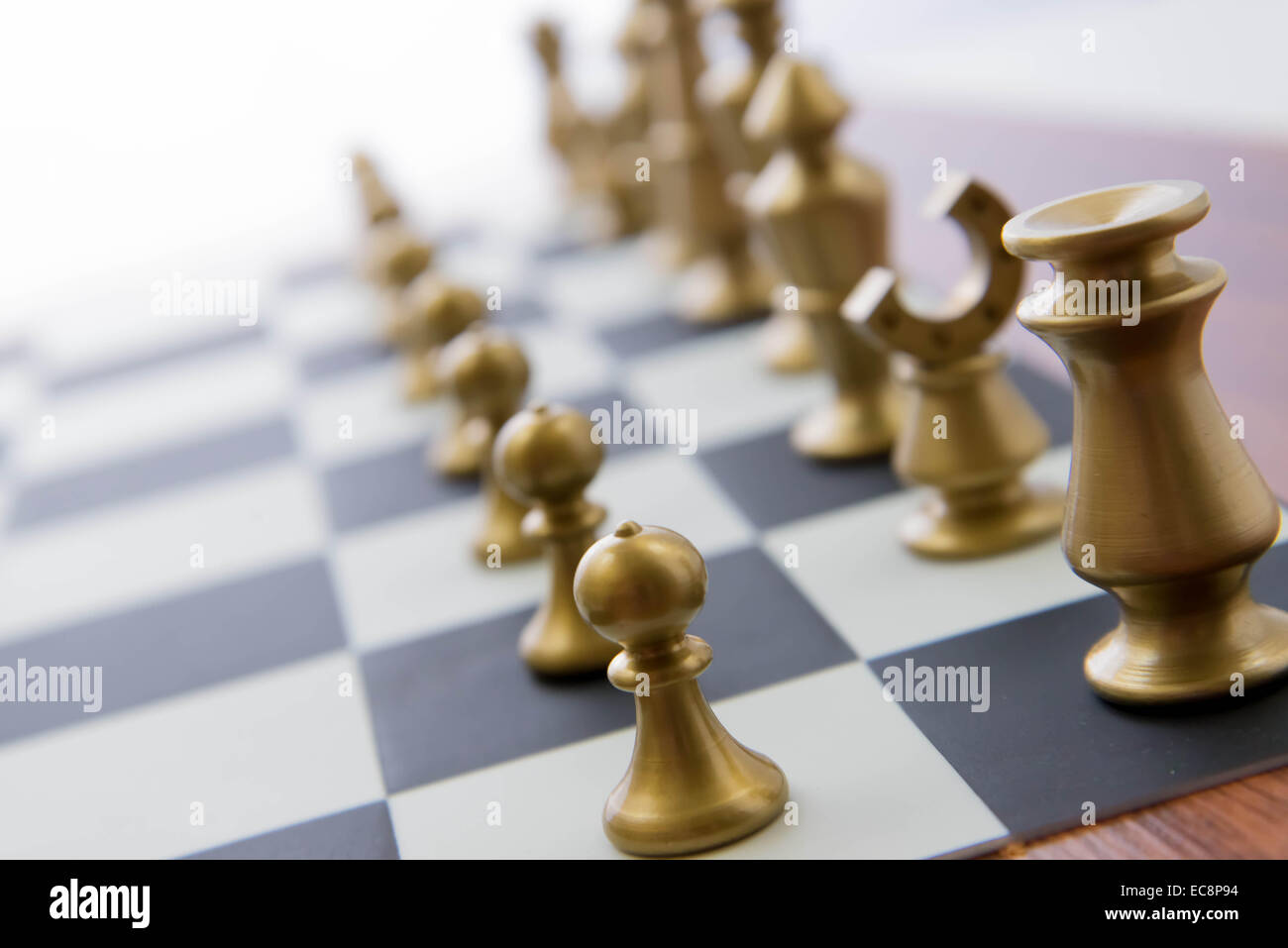 Classic chess game - gold playing pieces lined up on chessboard Stock ...