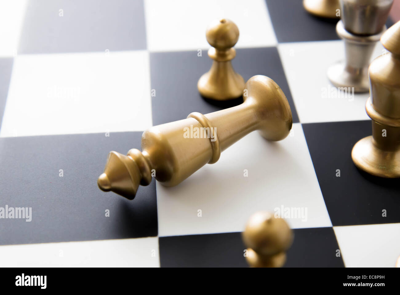 Classic chess game - fallen gold king on chessboard Stock Photo - Alamy