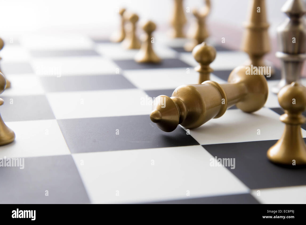 Classic chess game - fallen gold king on chessboard Stock Photo - Alamy