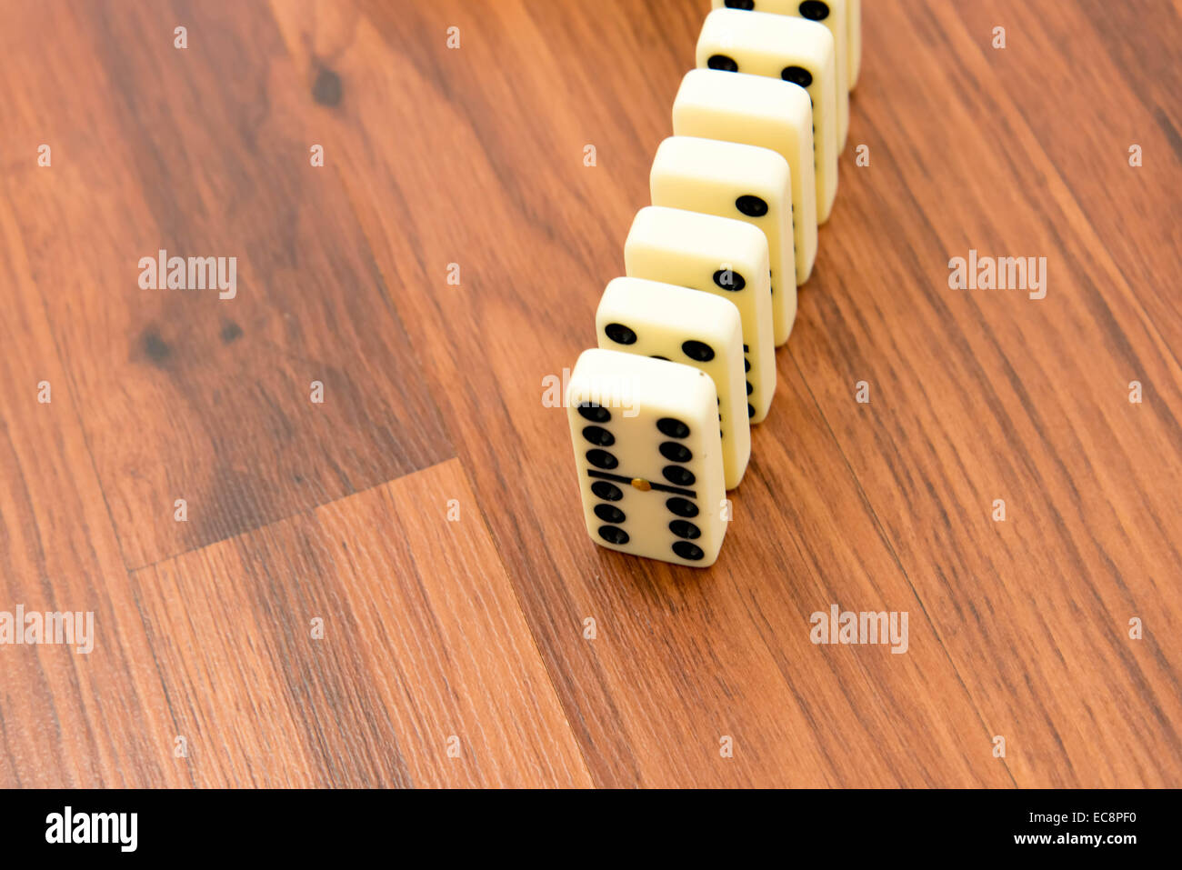 Domino tiles standing vertically in a line Stock Photo - Alamy