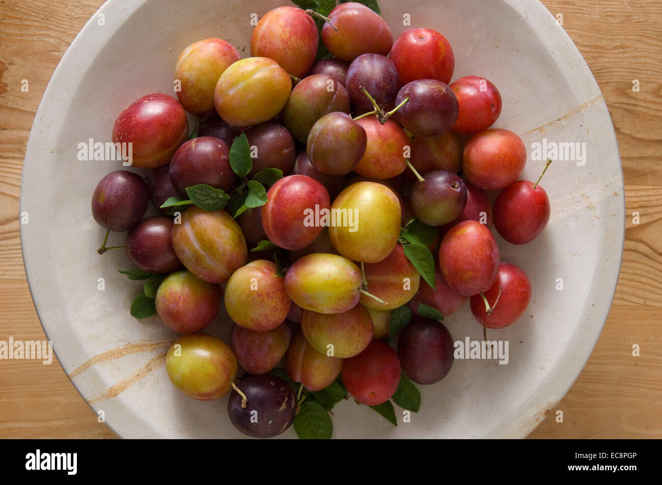 Selection of plums on traditional old kitchen scales hi-res stock ...