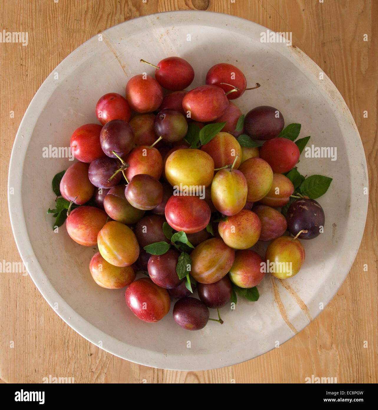 Selection of plums on traditional old kitchen scales hi-res stock ...