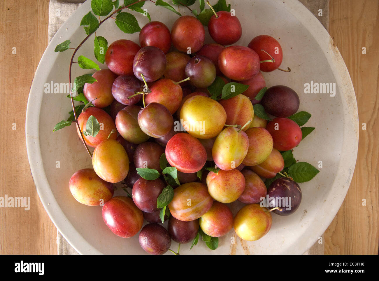 Selection of plums on traditional old kitchen scales hi-res stock ...