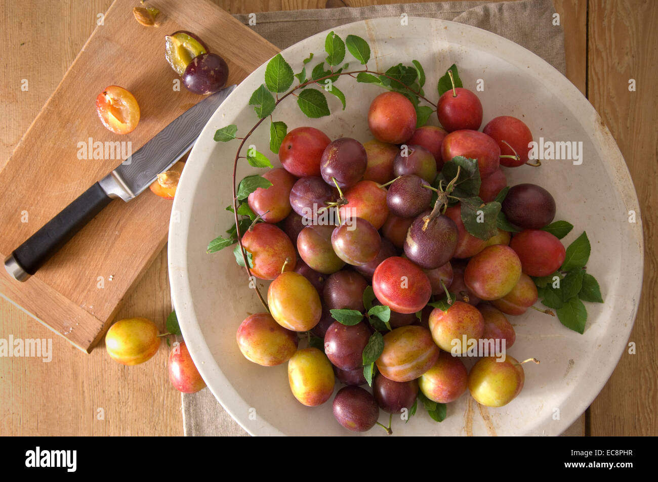 Selection of plums on traditional old kitchen scales hi-res stock ...